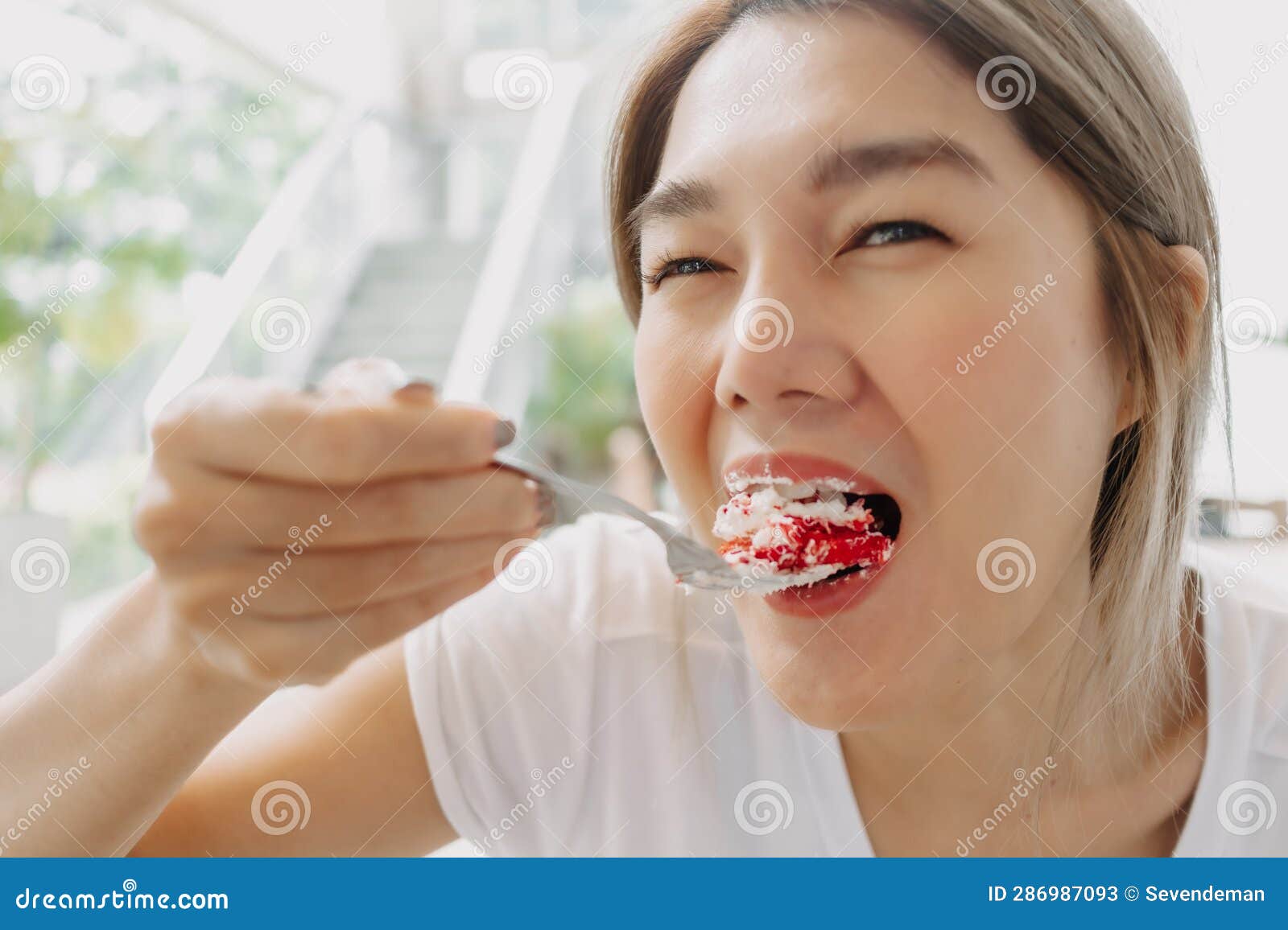 Funny Face Of Happy Woman Eating Cake Carelessly In The Cafe Stock