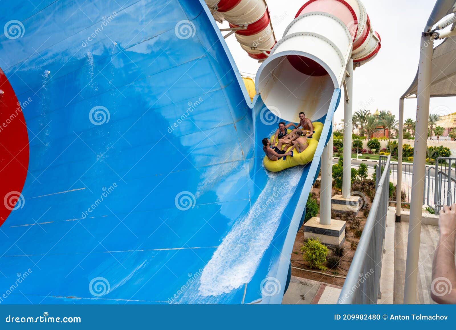 Friends Having Fun and Rolling on Big Water Slide Stock Photo - Image ...