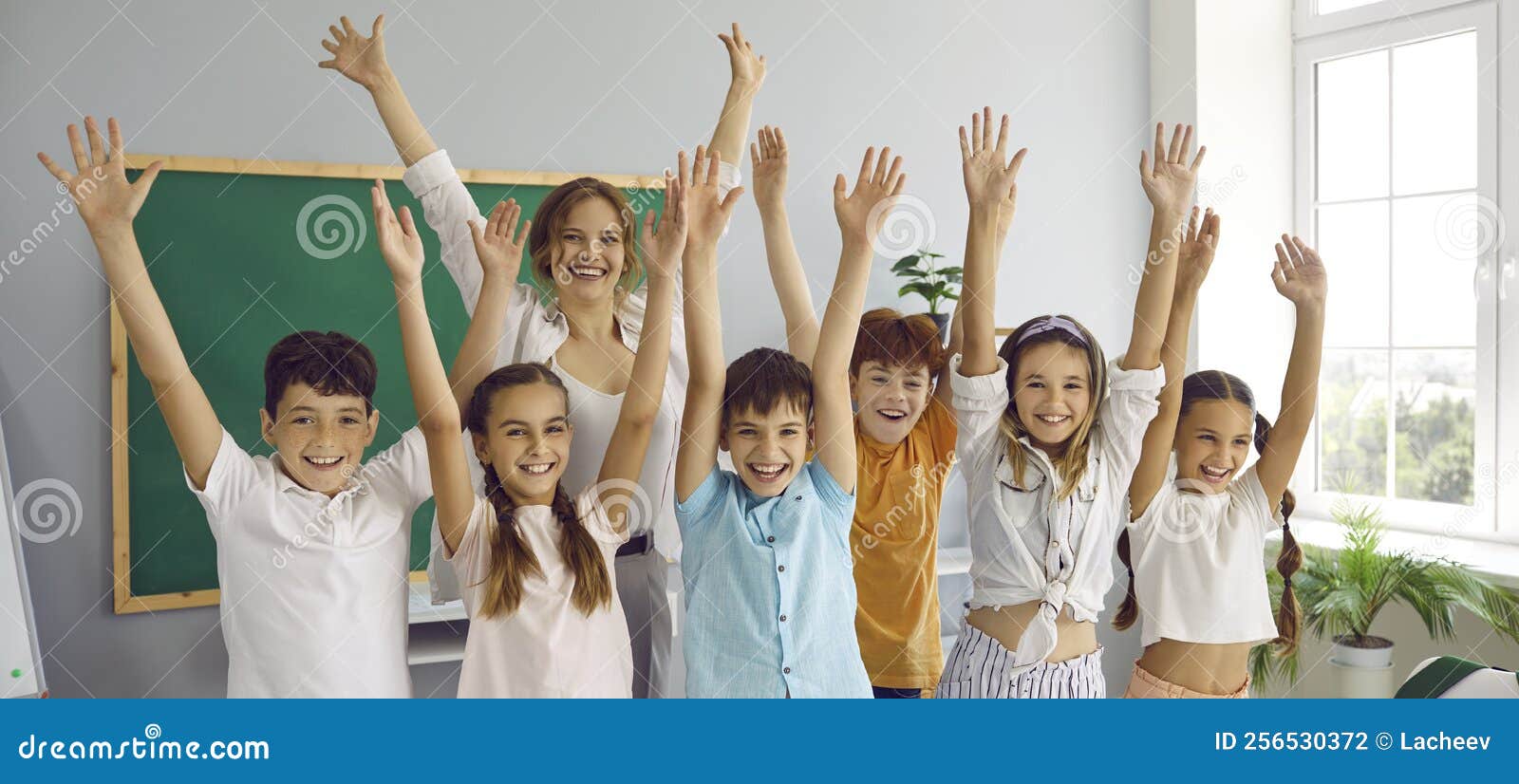 Funny Group Of Elementary School Classmates And Their Female Teacher Having Fun In Classroom 6153