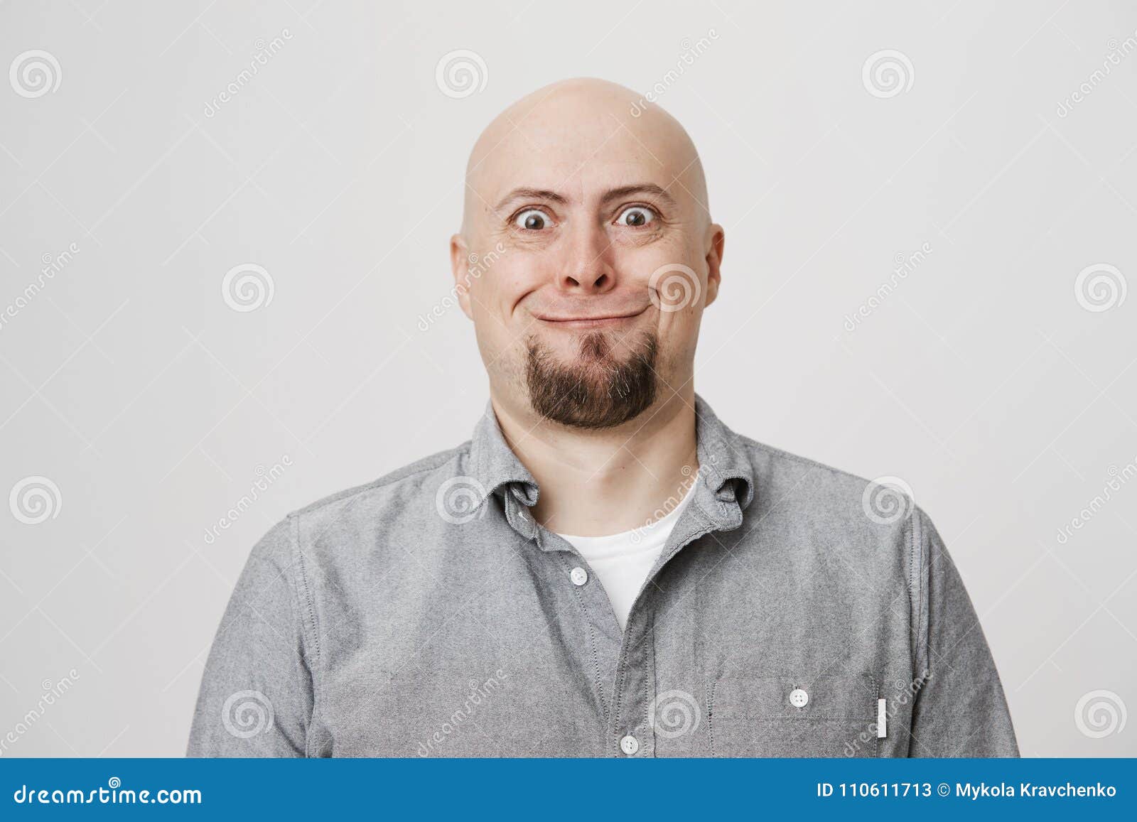 Funny Handsome Bald Caucasian Man With Beard And Weird Smile Staring