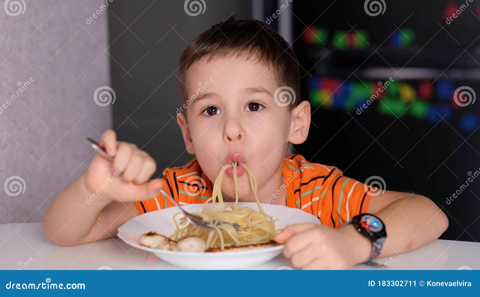 Funny Little Boy Eat Pasta in the Kitchen Table. Stock Image - Image of ...