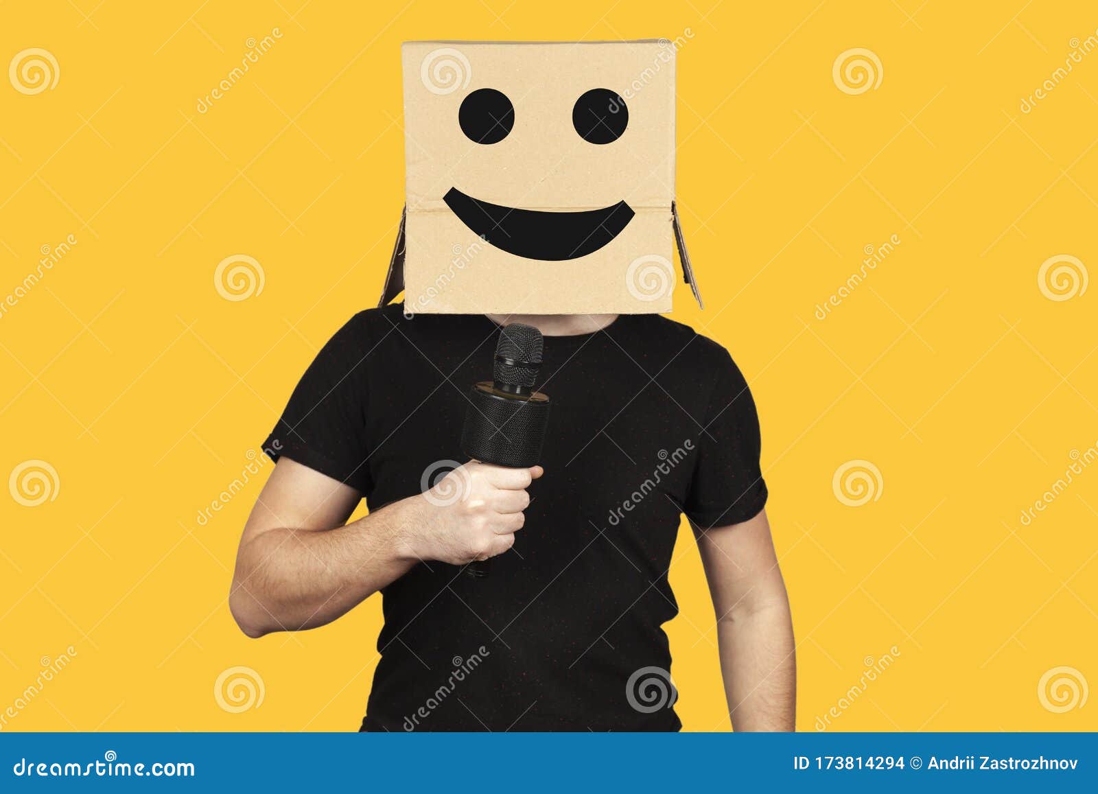 Funny Man with a Box on His Head and a Microphone in His Hands. Singing ...