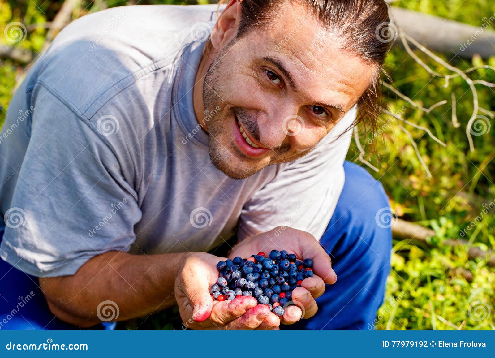 Funny Man in the Forest Holding a Bunch of Fresh Blueberries and ...