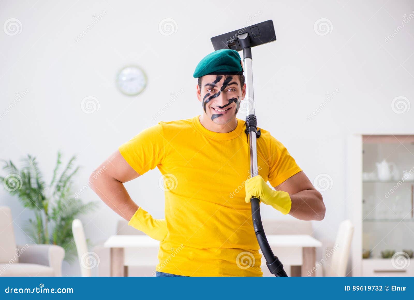 The Funny Man in Military Style Cleaning the House Stock Photo - Image ...