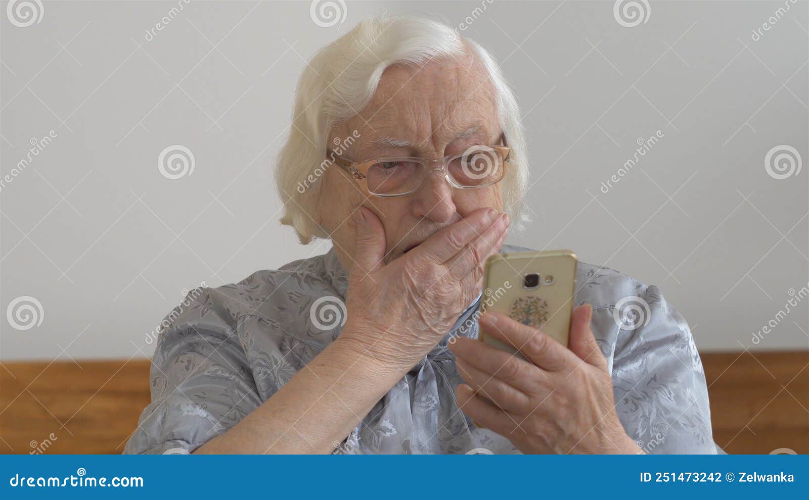 Funny Old Lady is Browsing Internet on the Smartphone Screen Stock ...