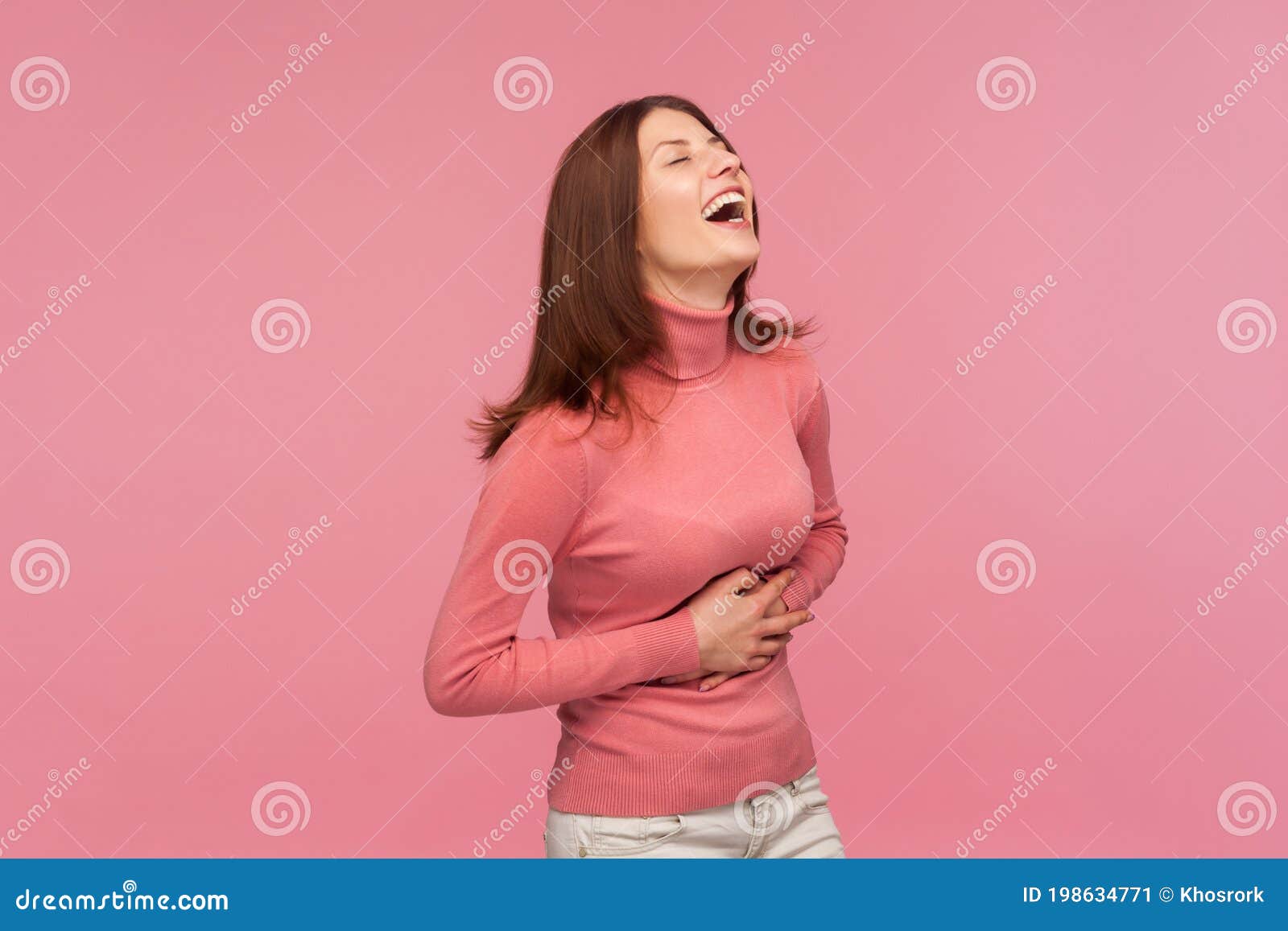 Funny Positive Brunette Woman In Pink Sweater Holding Her Belly And