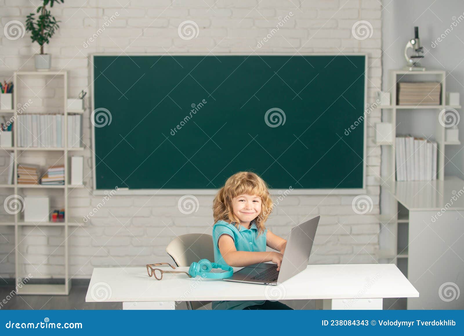 Funny Smiling School Boy Studying on Computer at School. Little Student ...