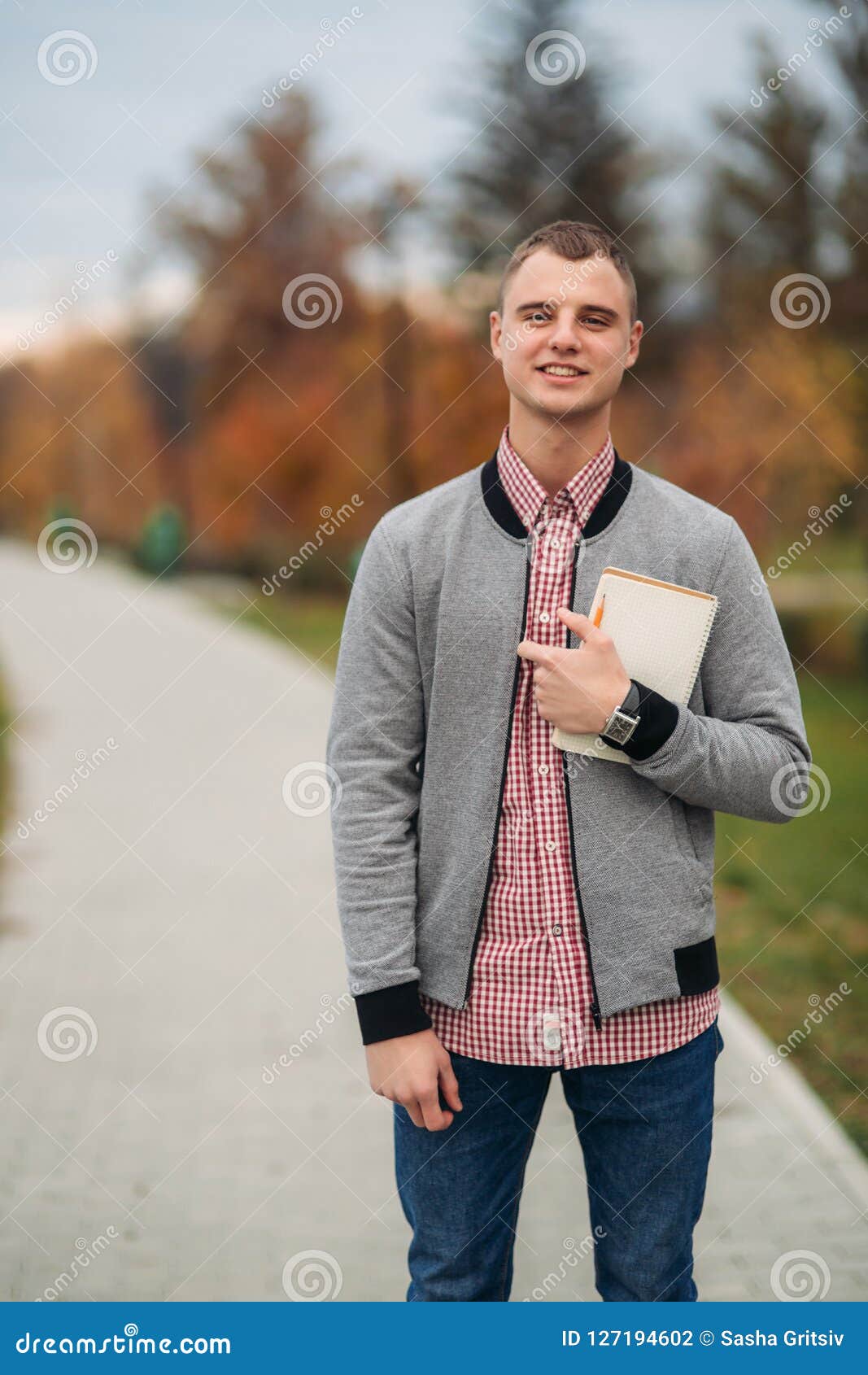 Funny Student with Notebook. Guy Stand in Park and Smile Stock Photo ...