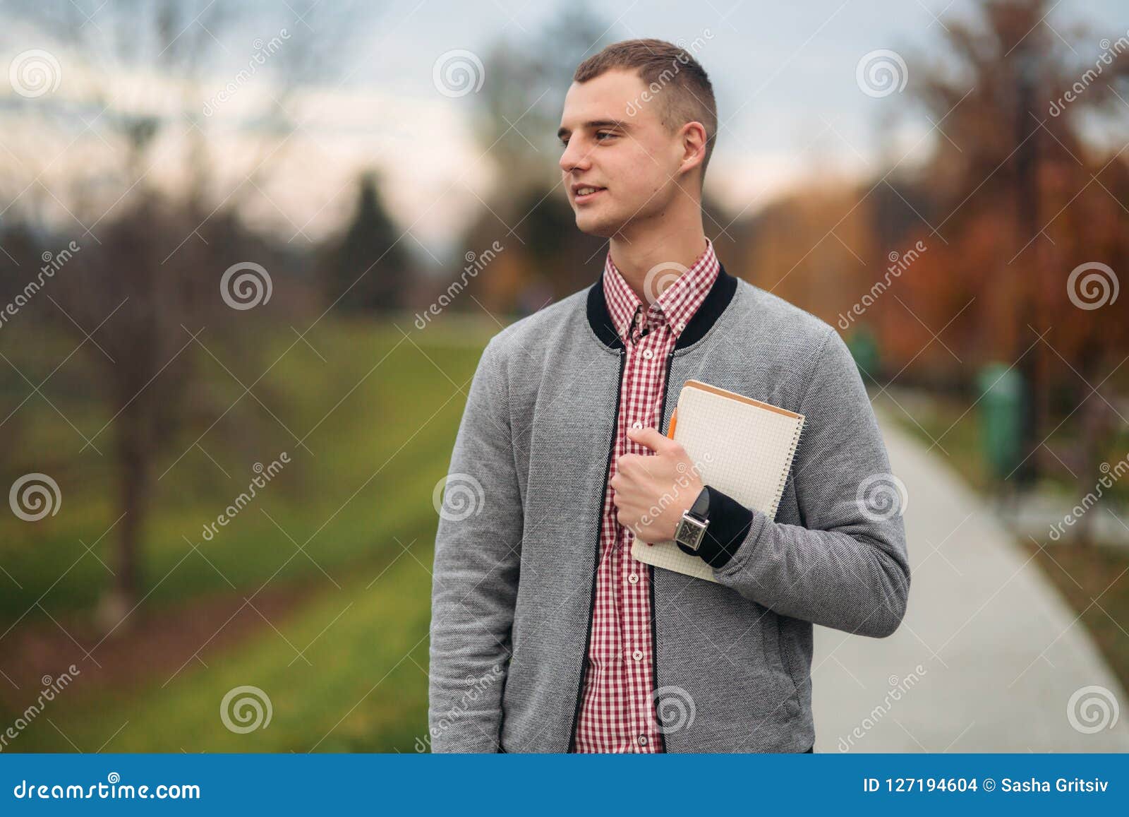 Funny Student with Notebook. Guy Stand in Park and Smile Stock Photo ...