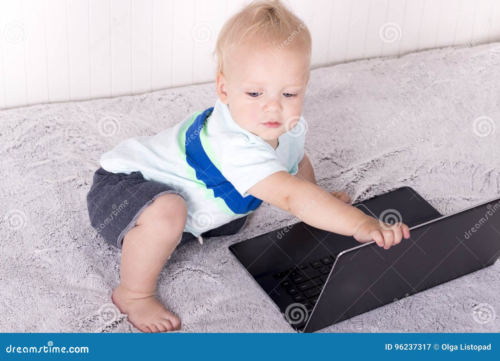 Funny Toddler Closes Down a Laptop. Concept of New Generation. Stock ...