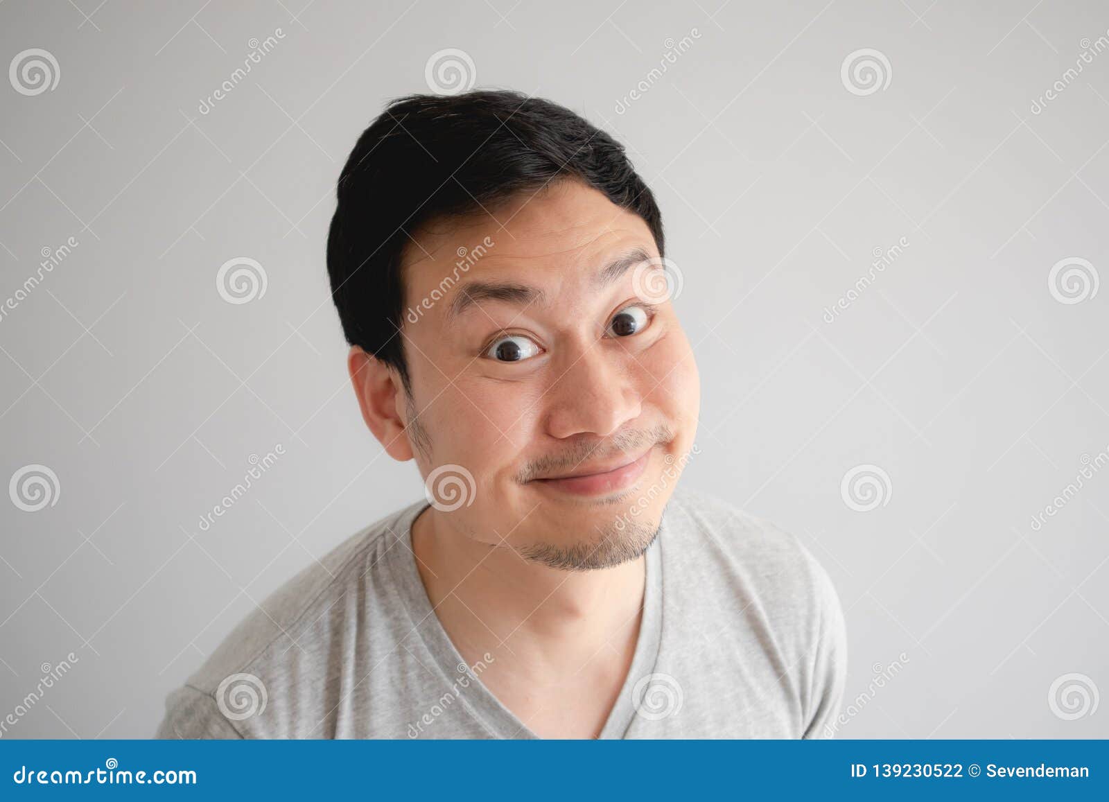 Funny Tricky Awkward Smirk Face of Man in Grey T-shirt Stock Photo ... Funny Tricky Awkward Smirk Face of Man in Grey T-shirt Stock Photo ...