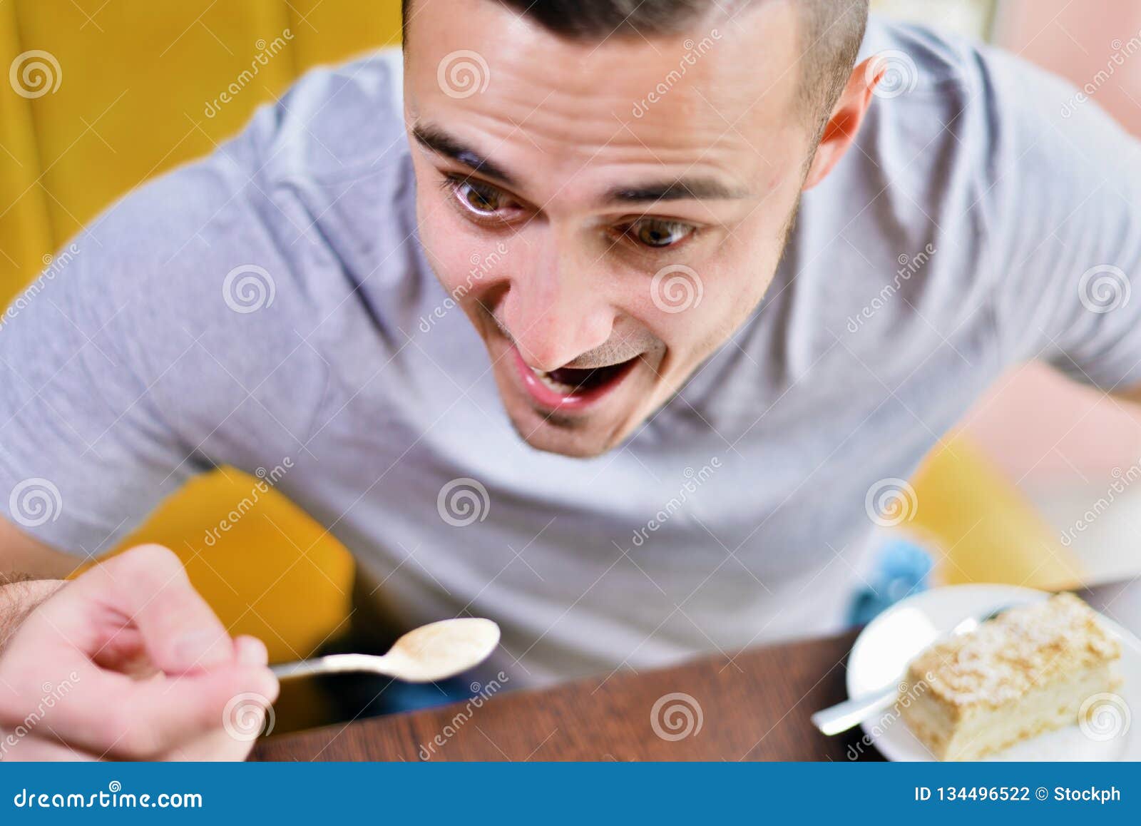 Funny young guy in cafe stock photo. Image of cheerful - 134496522