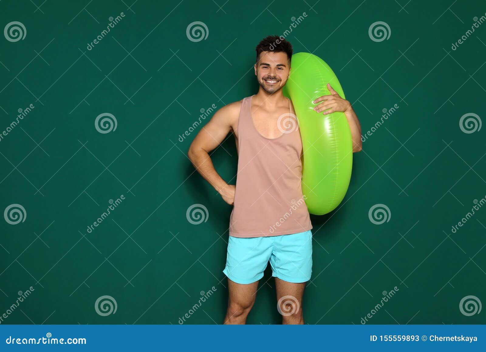 Funny Young Man with Bright Inflatable Ring on Dark Green Background ...