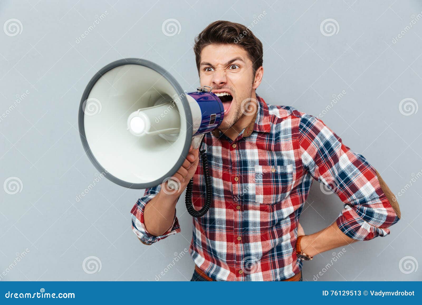 Furious Aggressive Young Man Standing and Shouting with Loudspeaker ...