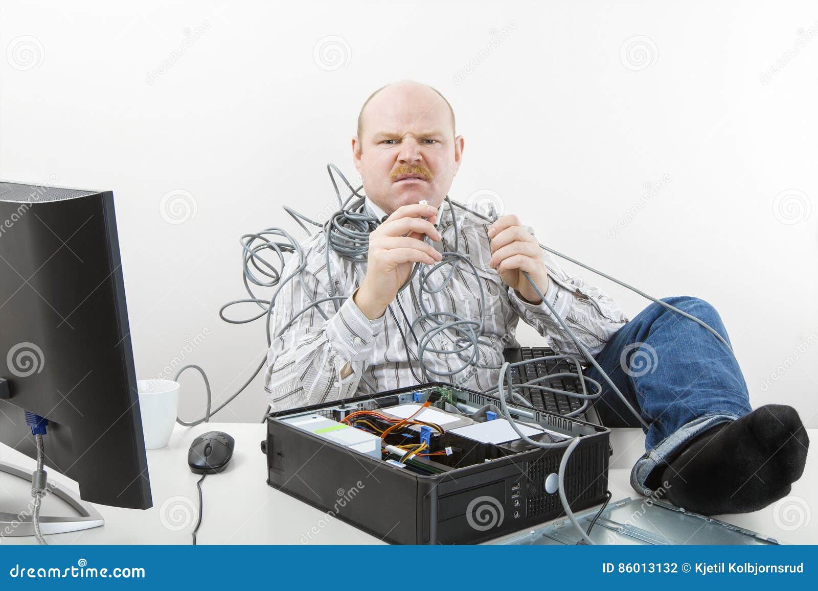Furious Businessman Holding Tangled Cables of Computer at Desk Stock ...