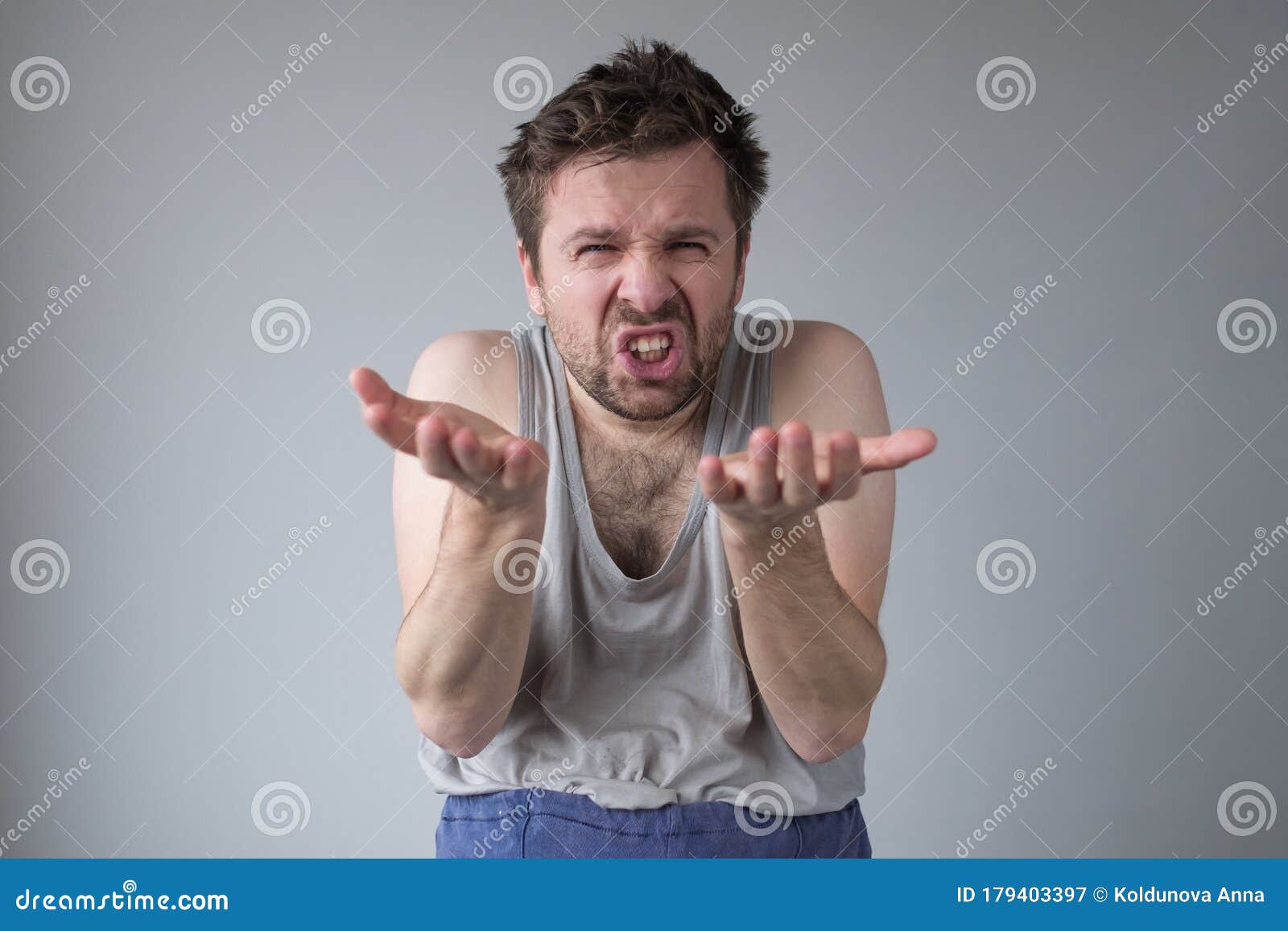 Man Standing with Raised Fists and Clenched Teeth, Experiencing Strong ...