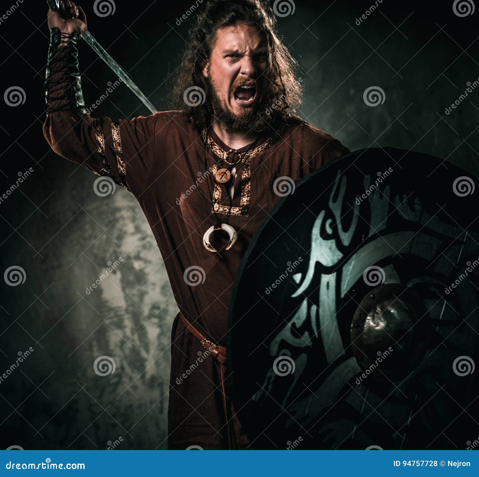 Furious Viking with Sword in a Traditional Warrior Clothes Stock Photo ...