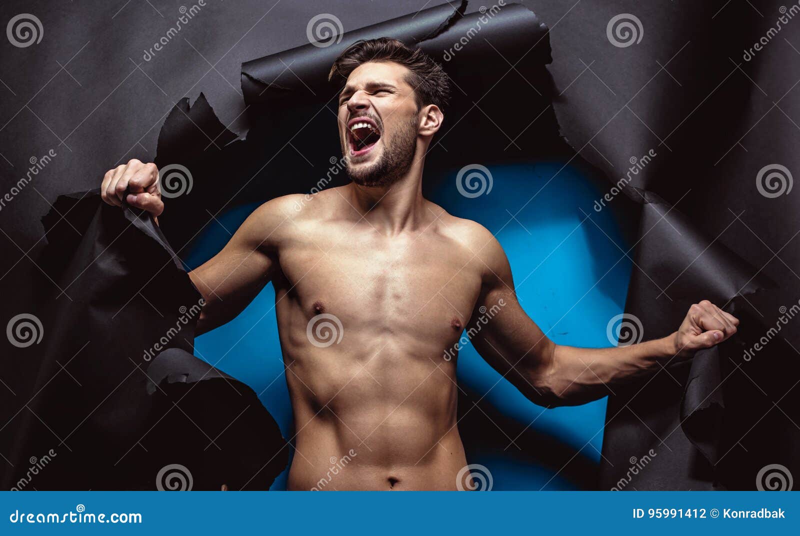 Furious Young Man Tearing Up the Background Stock Photo - Image of ...