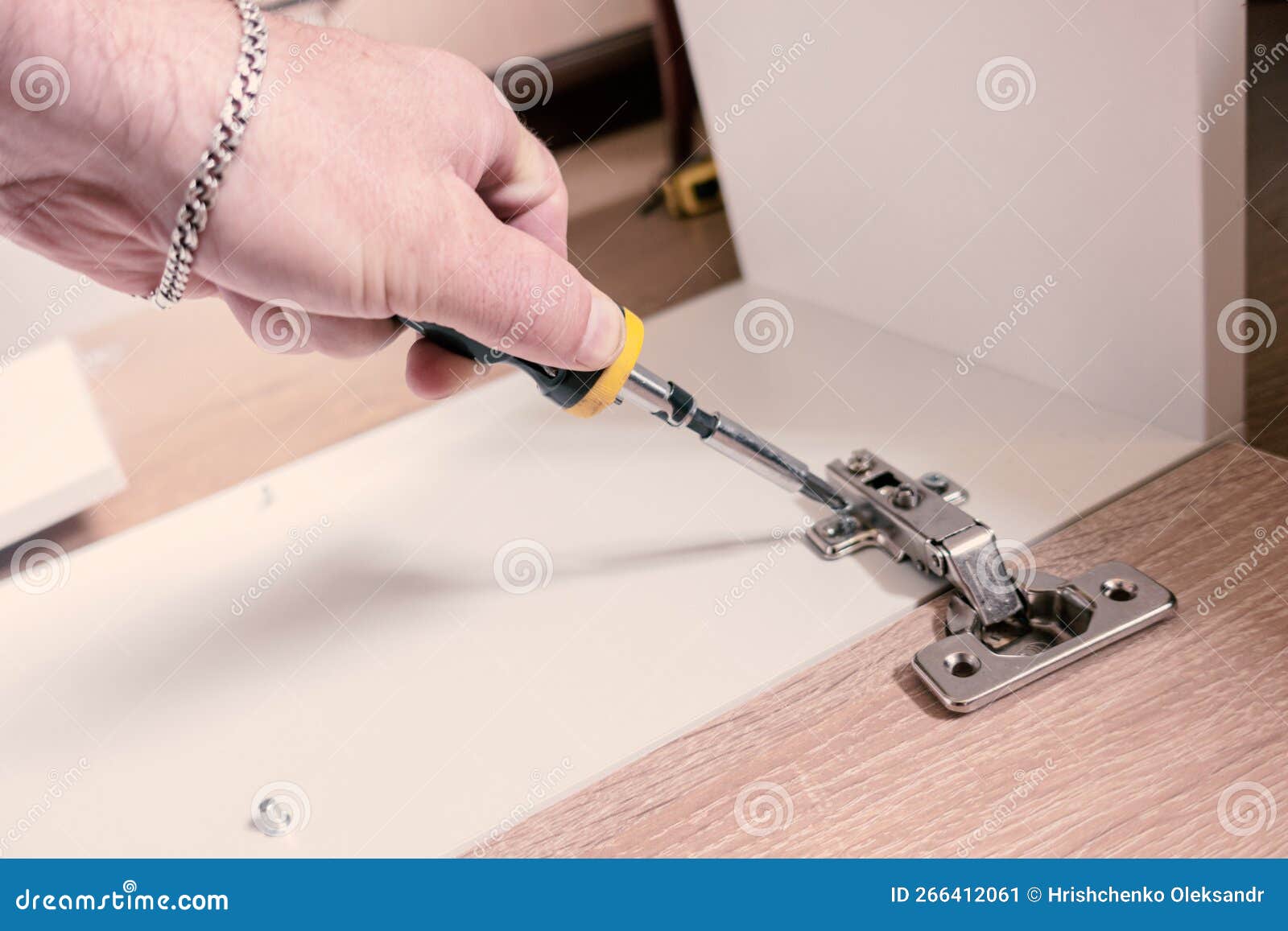 Furniture Assembly. the Master Fastens the Hardware Hinges To the Door ...