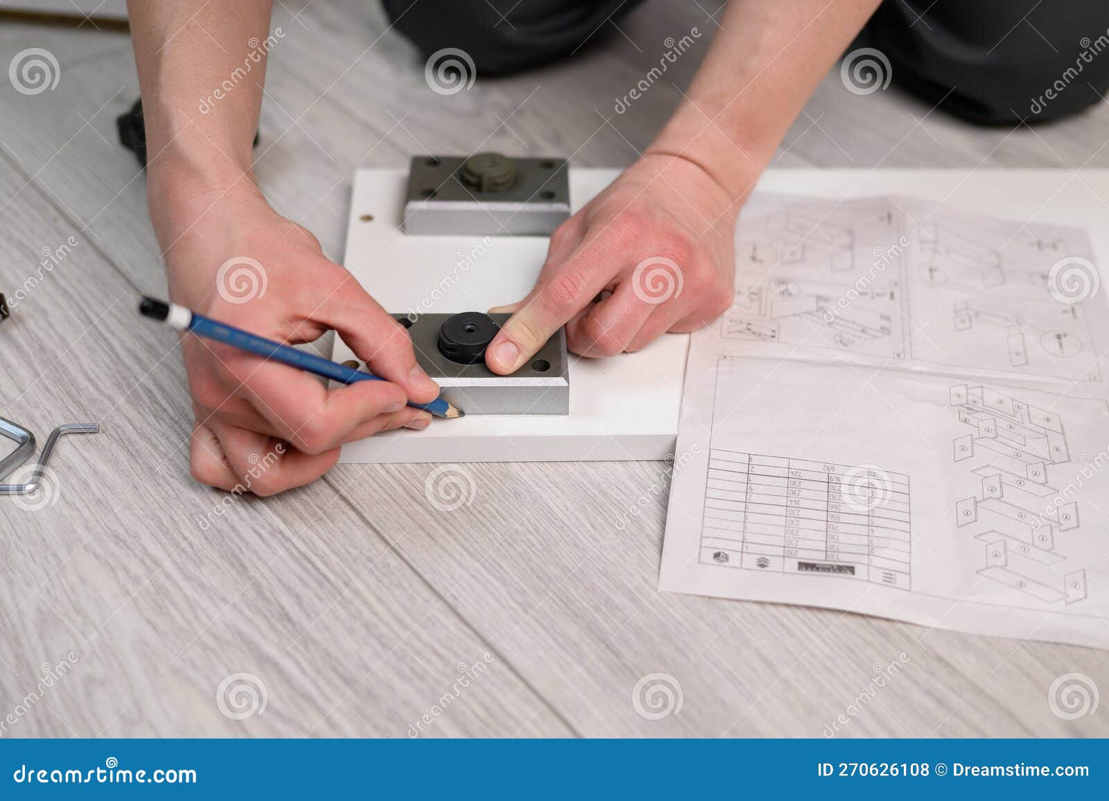 Furniture Assembly. the Worker Makes Markings with a Pencil for ...