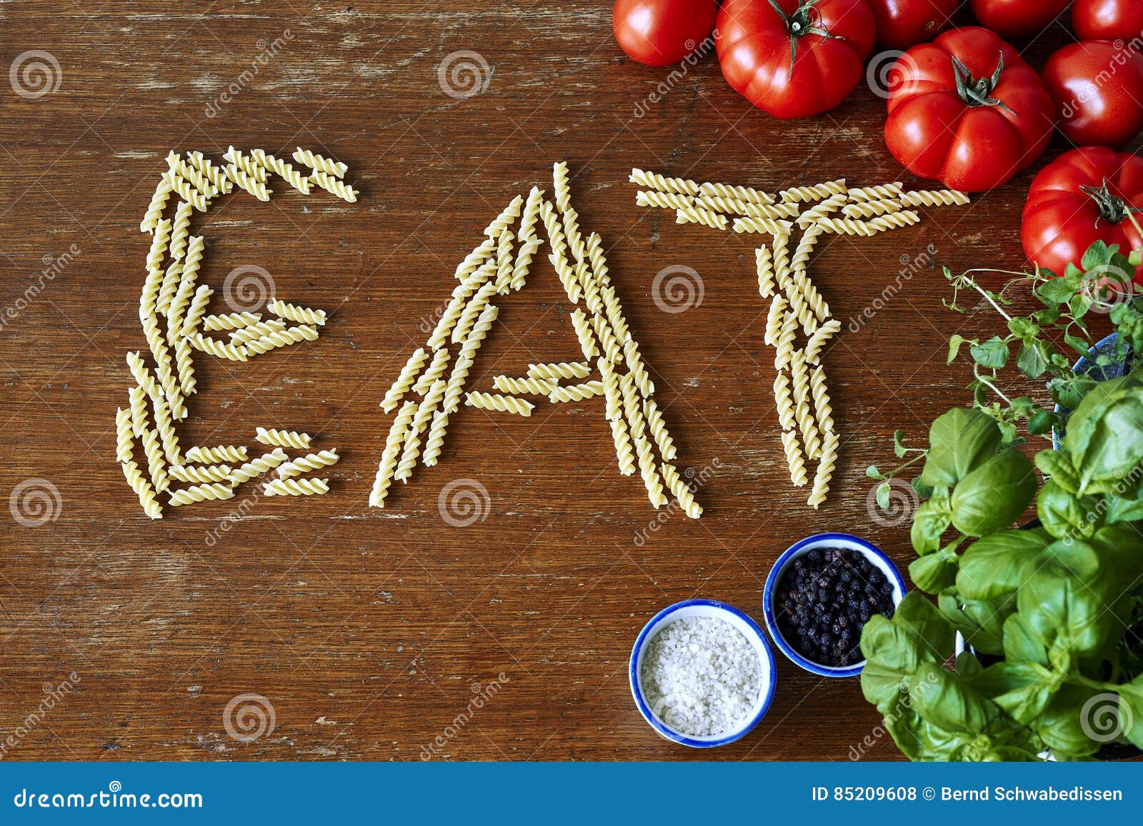 Fusilli Pasta Tomatoes and Herbs Forming the Word Eat Stock Photo ...