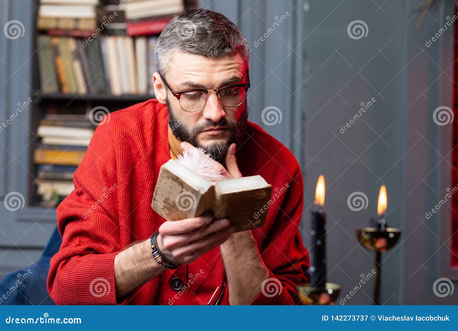 Future Predictor Wearing Glasses Reading Little Old Book about ... Future Predictor Wearing Glasses Reading Little Old Book about ...