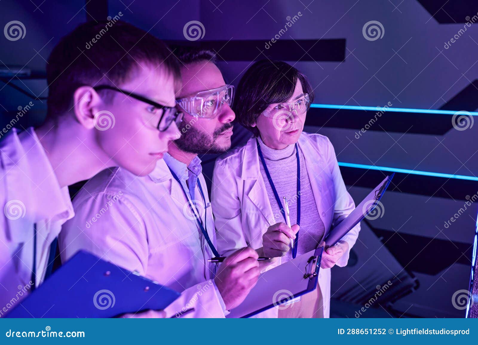 Futuristic Analysis: Three Scientists Delve into Stock Photo - Image of ...