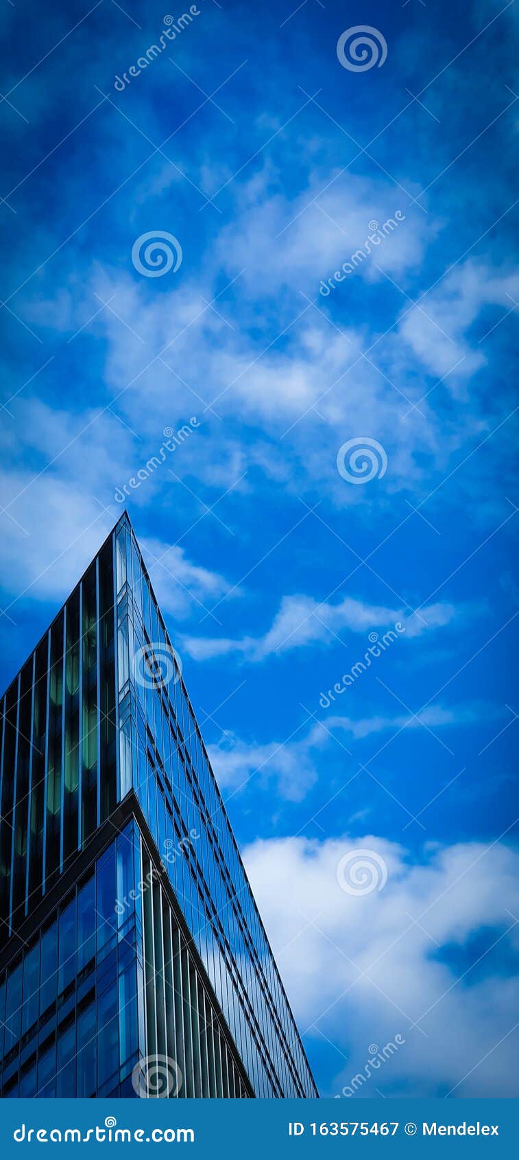Futuristic Triangular Building Against a Clear Blue Sky Stock Image ...