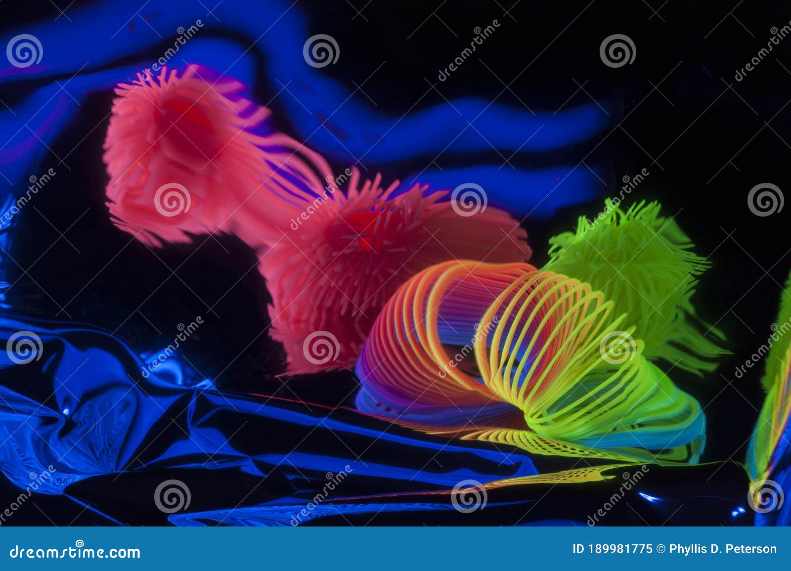 Fuzzy and Circular Objects are Lit with Fluorescent Colors Against a ...