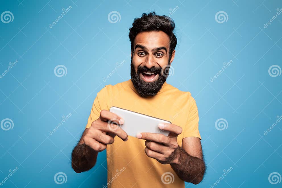 Gadget Addiction Concept Happy Middle Aged Indian Man Playing Mobile Games On Cellphone 0766