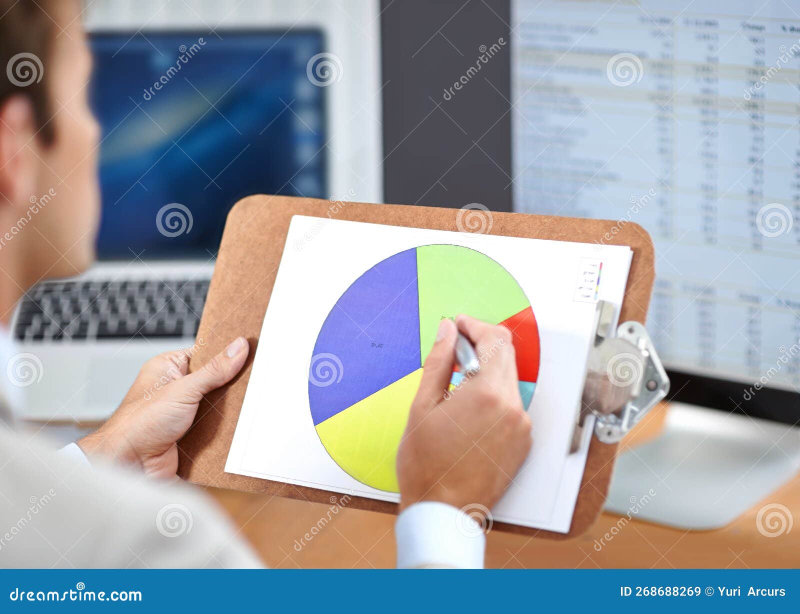 Gaining Insight through Graphs. Over the Shoulder Shot of a Businessman ...