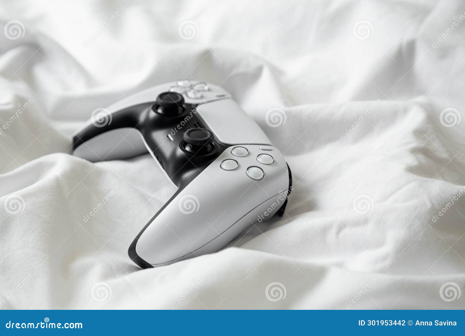 Game Controller, Lying on White Sheets of Bed at Home. Stock Photo ...