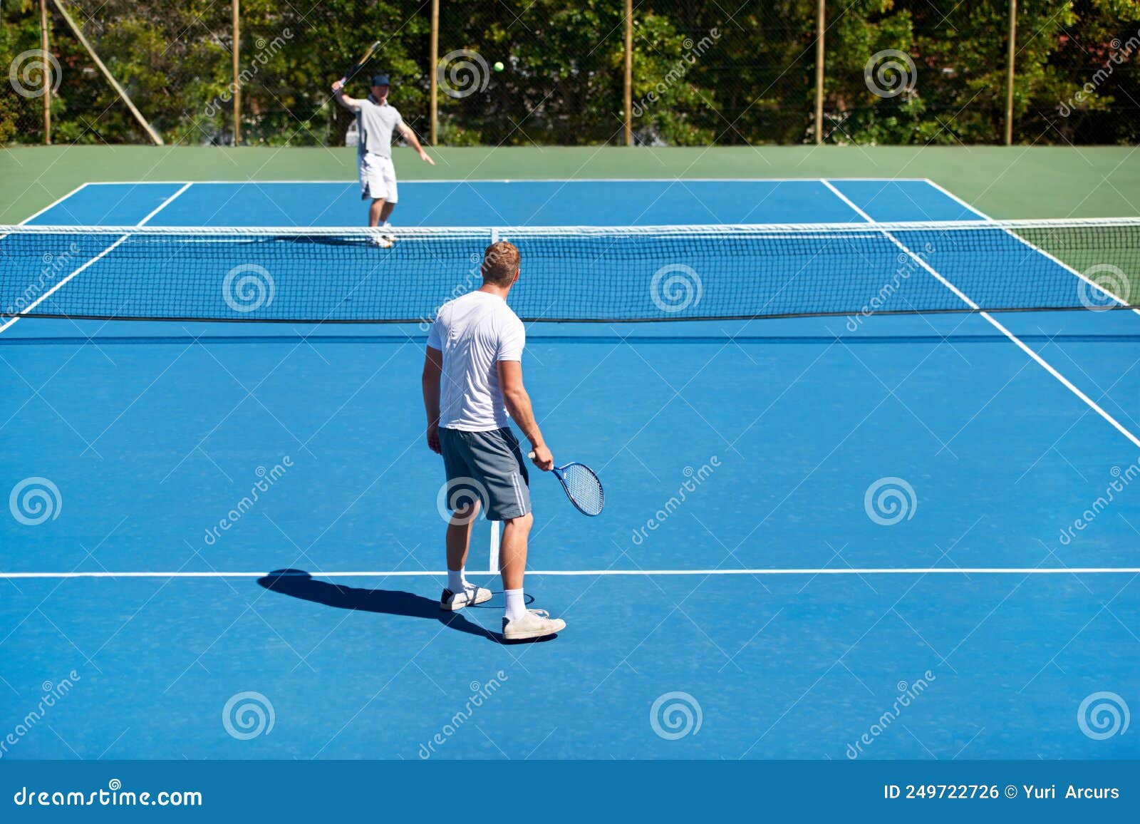 The Game is on. People Playing Tennis on a Tennis Court. Stock Photo ...