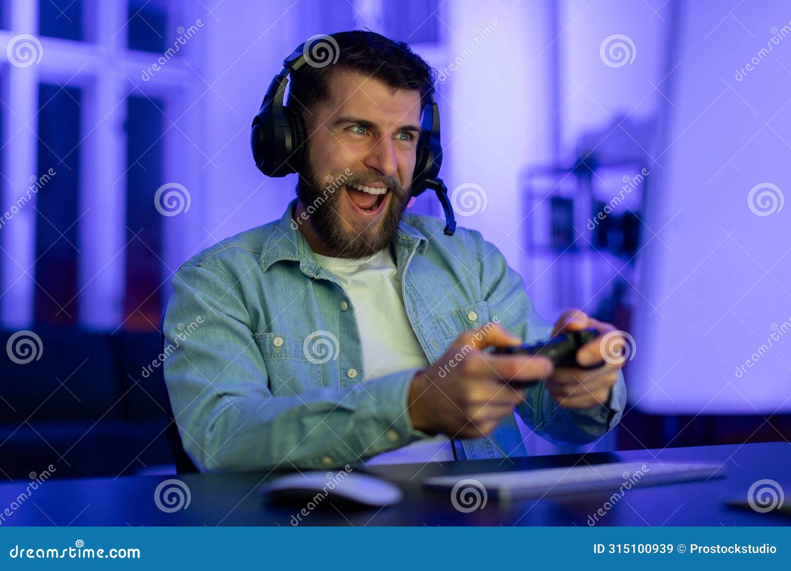 Gamer Playing with Controller and Headphones at Home Stock Image ...