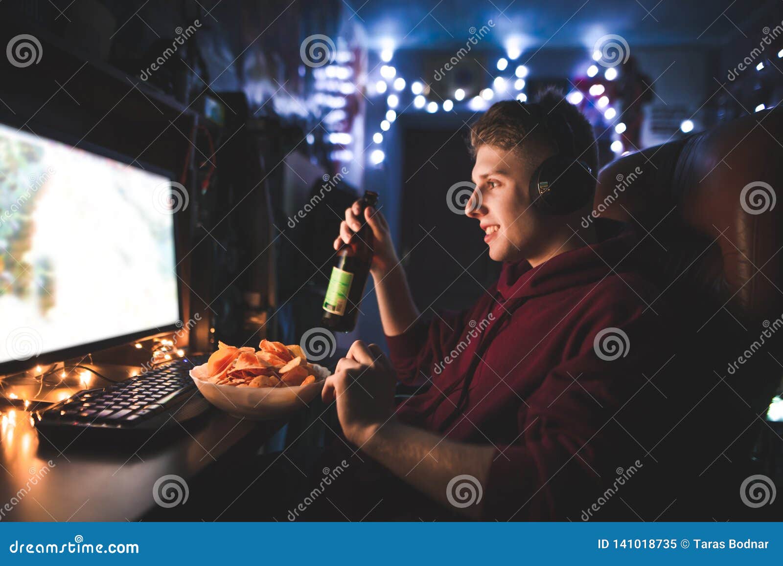 Gamer Plays Video Games on a Computer and Eats Chips Stock Image ...