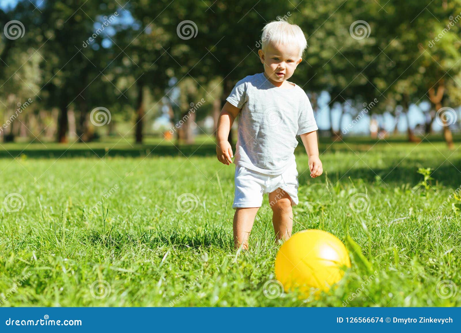 Cute Small Boy Kicking a Ball Outside Stock Photo - Image of preschool ...