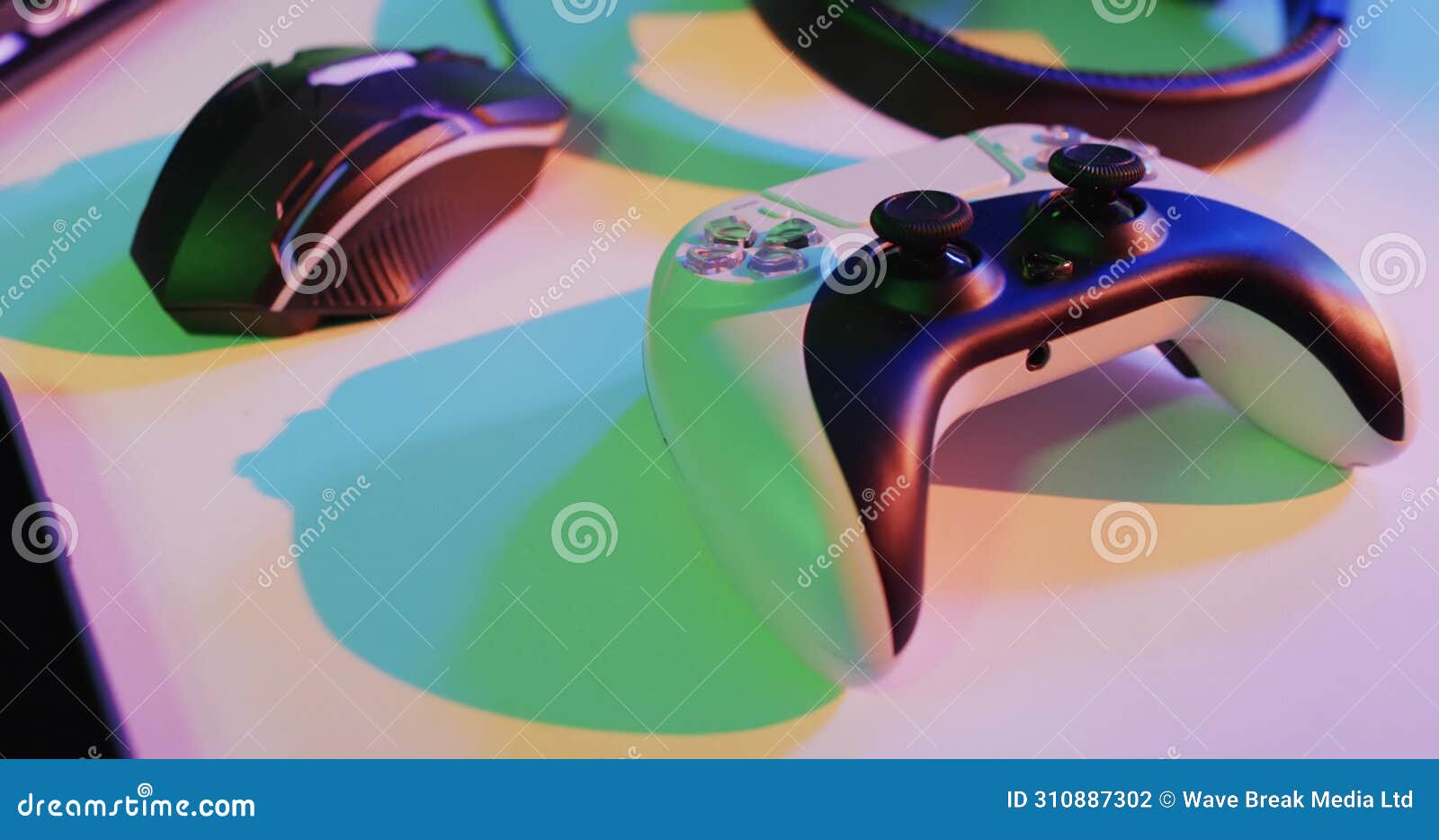 A Gaming Controller and Mouse Rest on a Colorful Surface Stock Photo ...