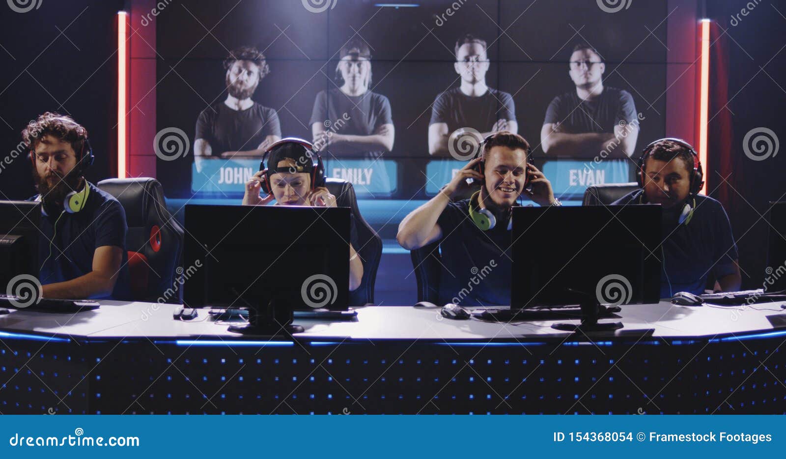 Gaming Team Sitting Down at Computers Stock Photo - Image of ...