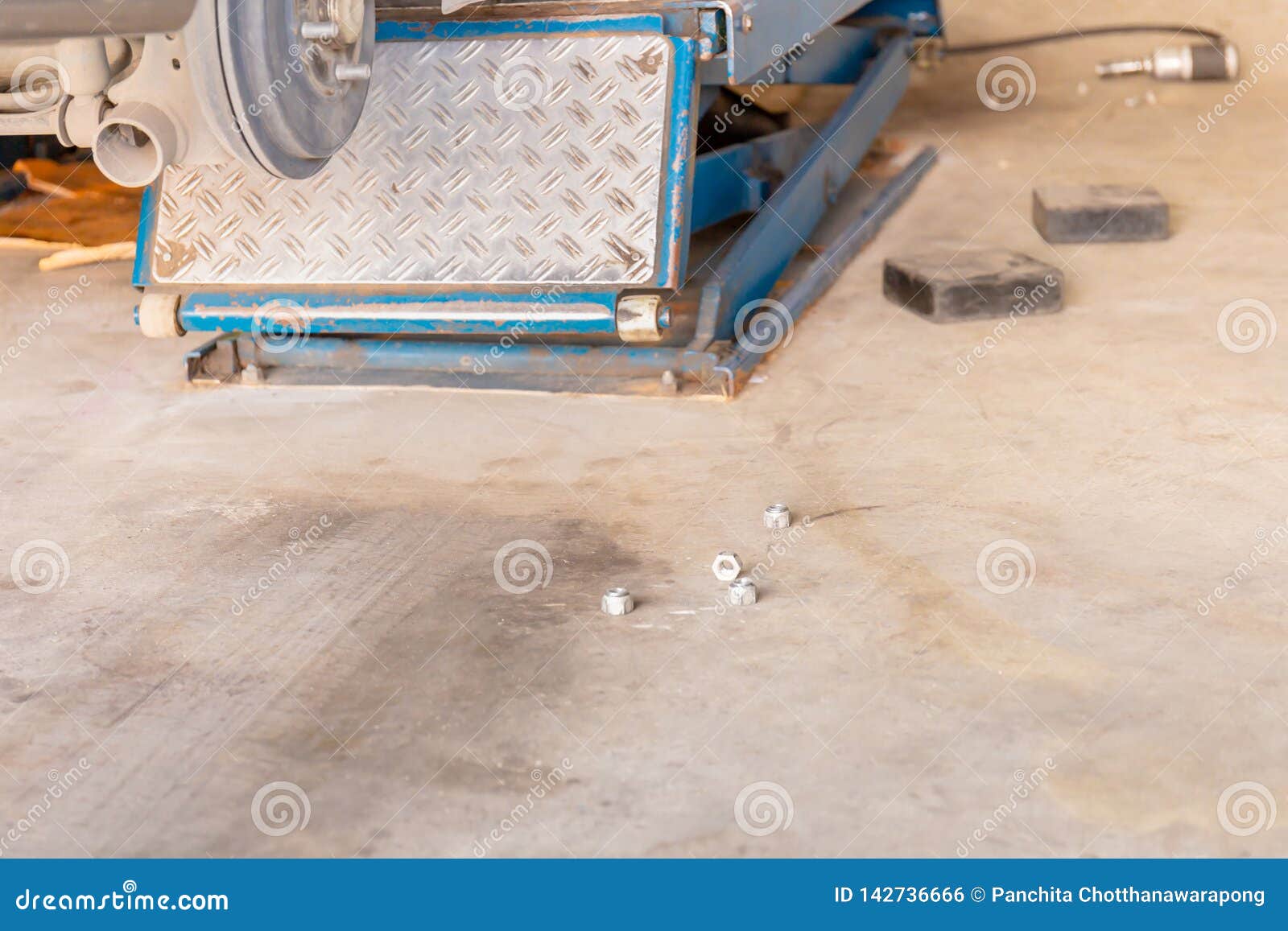 Garage Floor with Nut and Car Wheel Clamp Machine in Process of New ...
