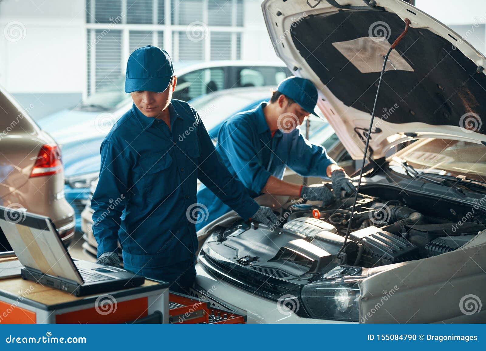 Garage Workers Repairing Car Stock Photo - Image of engineer ...
