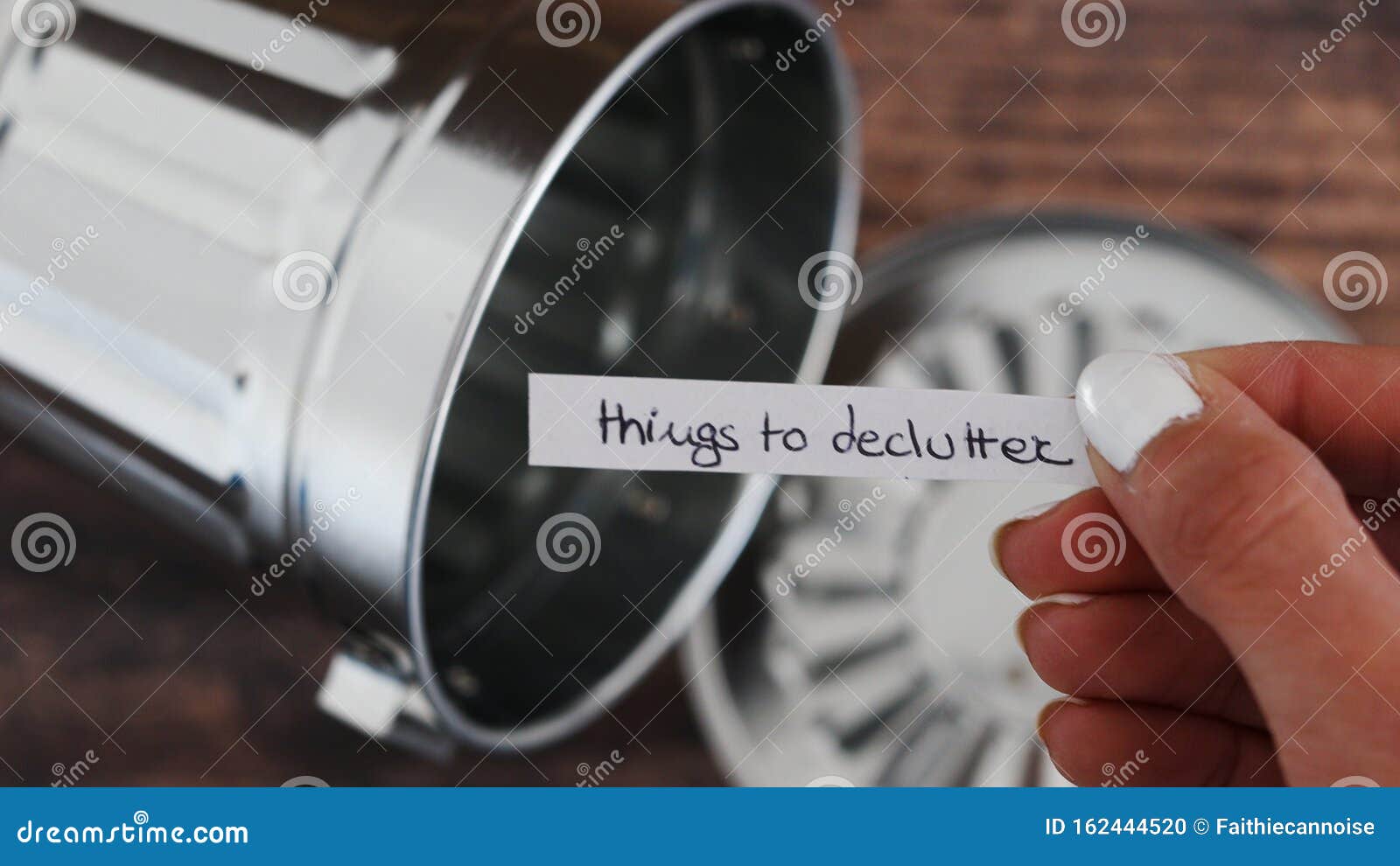 Garbage Bin and Hand Holding Label Saying Things To Declutter Stock ...