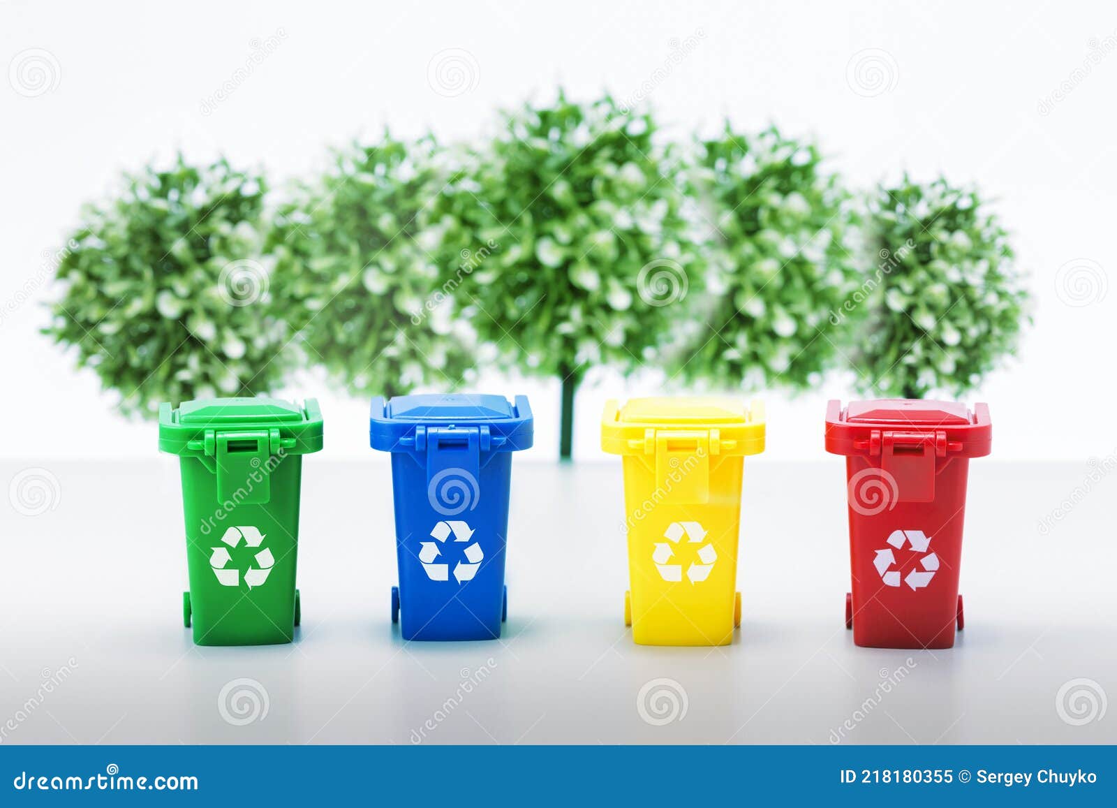 Garbage Cans with Sorted Garbage Against Green Trees. Stock Image ...