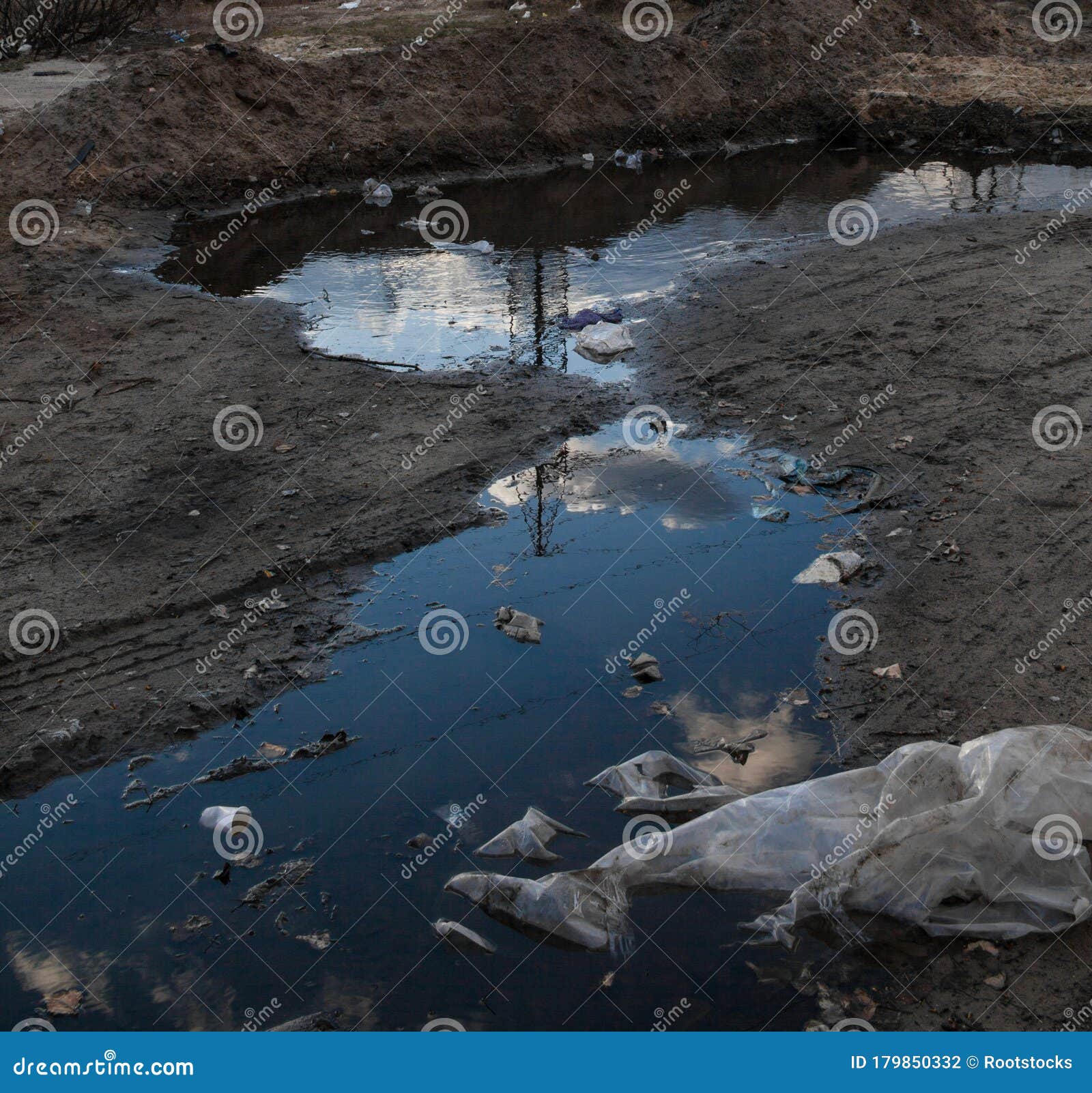 Garbage in the Mud on the Dirt Road Stock Photo - Image of polythene ...