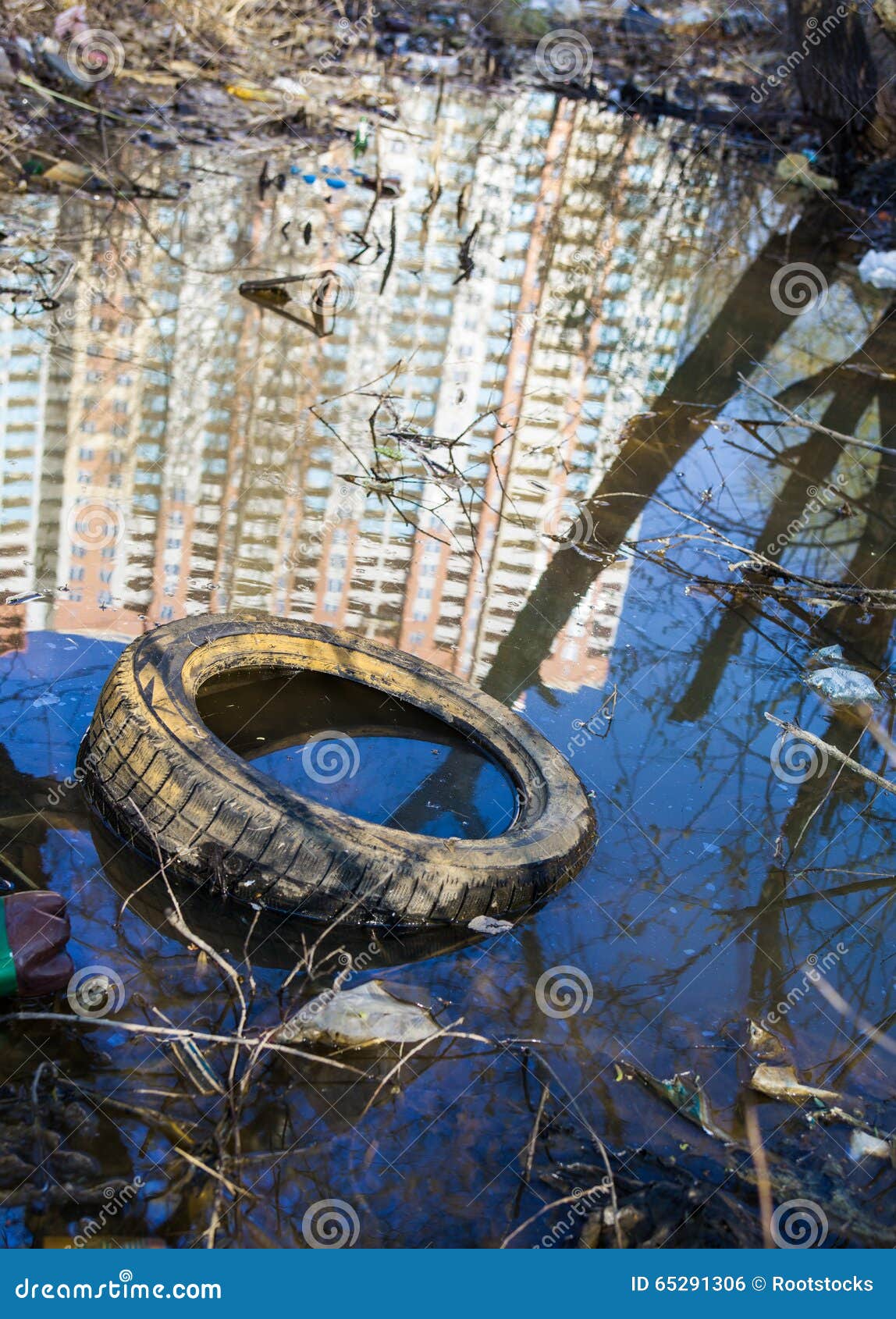 Garbage, Old Tire and Reflection of the High-rise in the Water Stock ...
