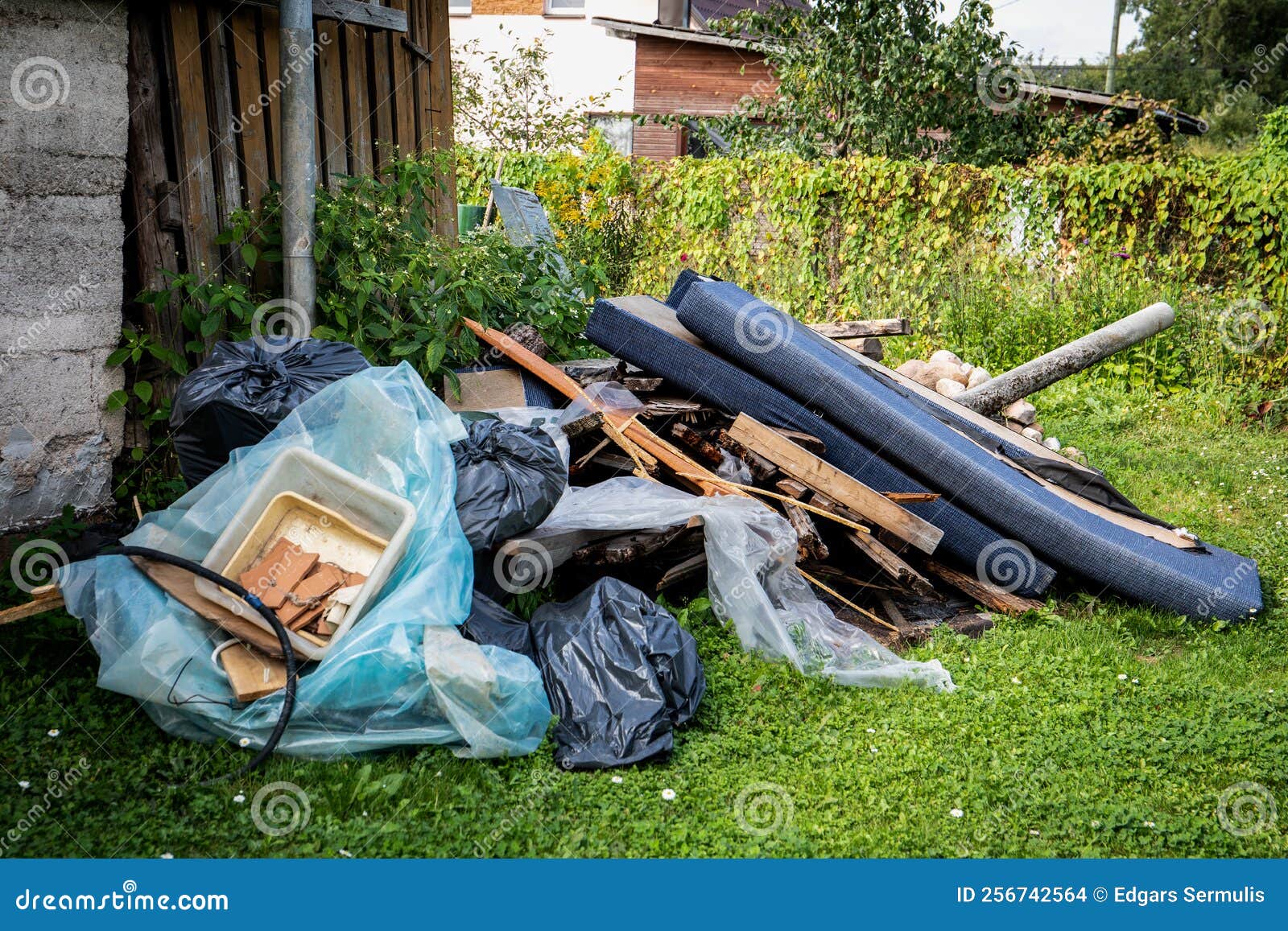 Garbage and a Pile of Construction Debris in the Yard of a House Stock ...