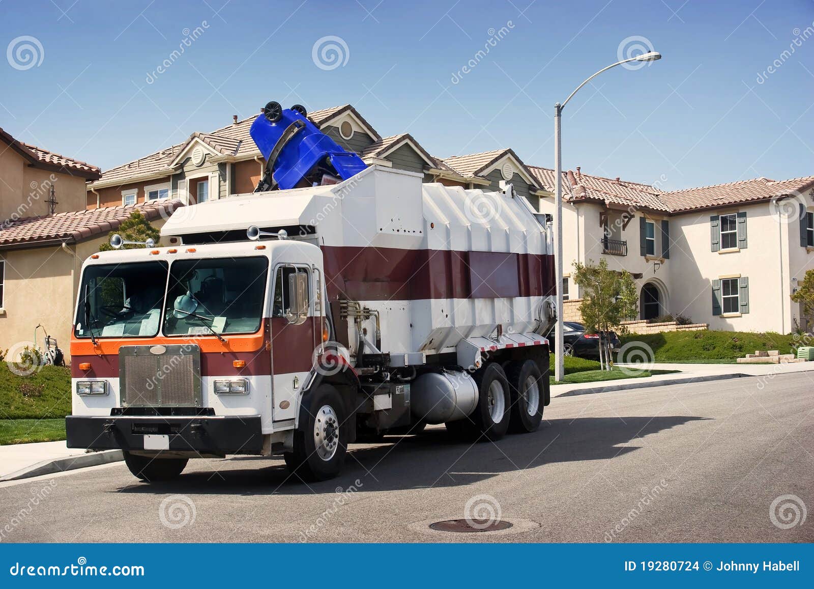 Garbage Truck Lifts A Container With Garbage For Unloading Royalty-Free ...