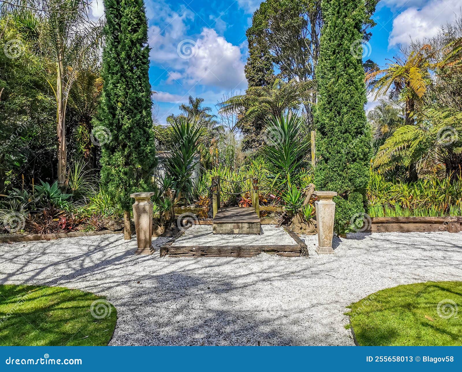 Garden Decorations on a Walking Pass with Tall Trees in the Afternoon ...