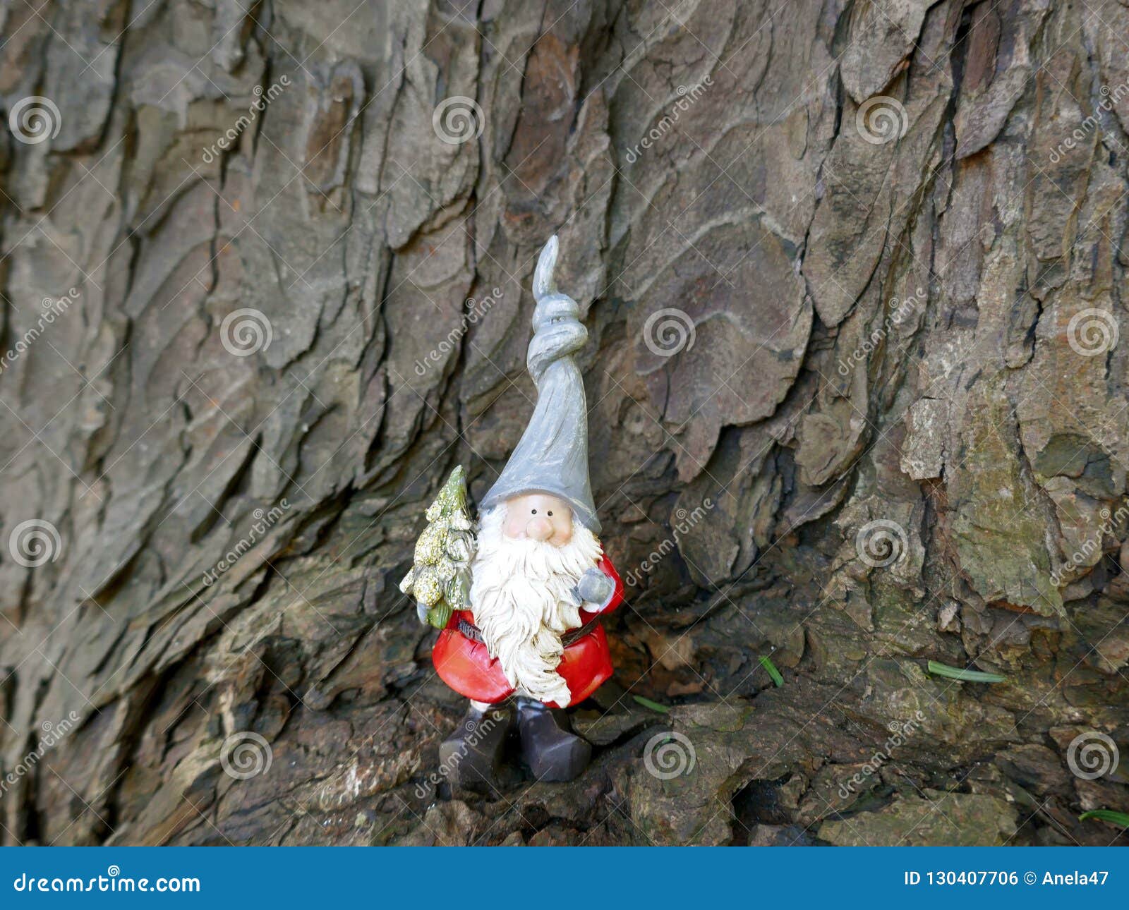 Christmas Garden Gnome in the Forest, in Front of an Old Tree Trunk ...