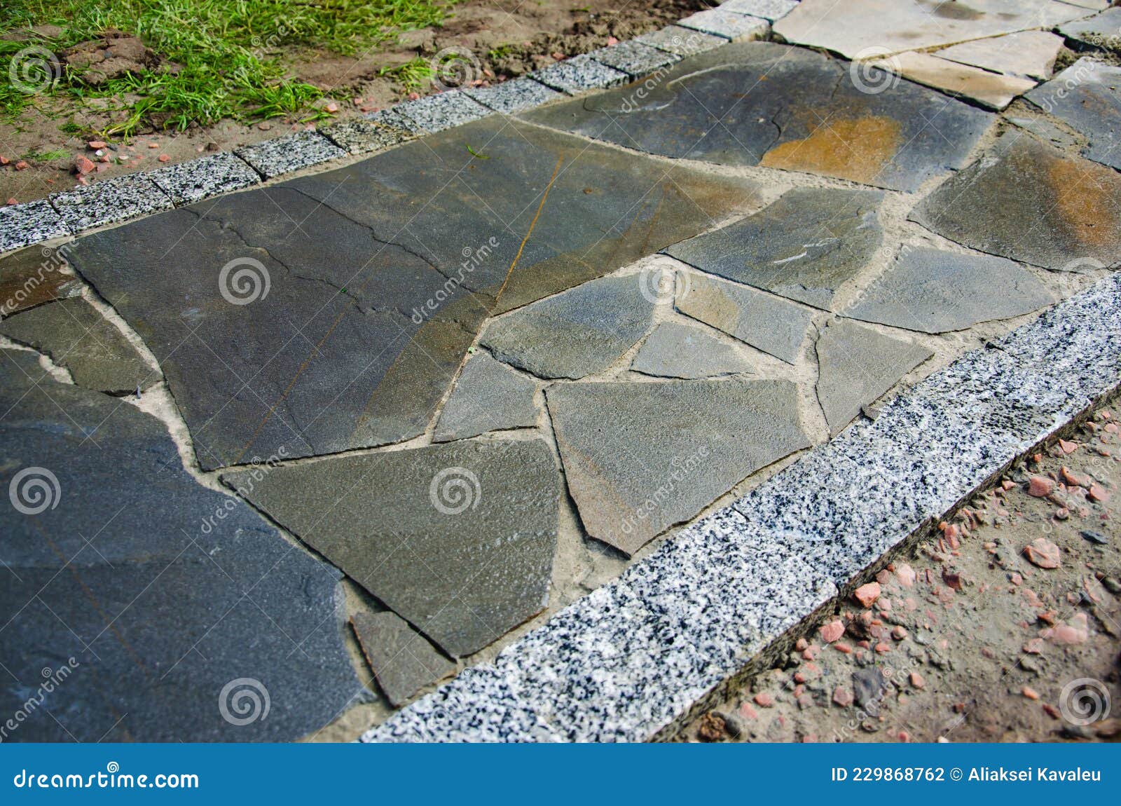 Garden Path with Natural Stone Slabs and Edging Made of Stones Stock ...