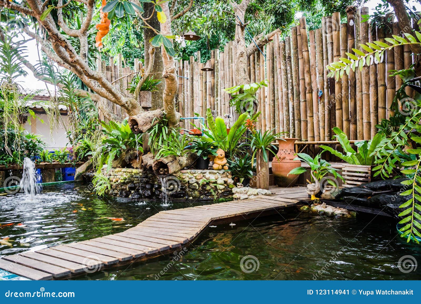 Garden with Pond of Koi Fish and Decorated Bamboo Wall Stock Image ...